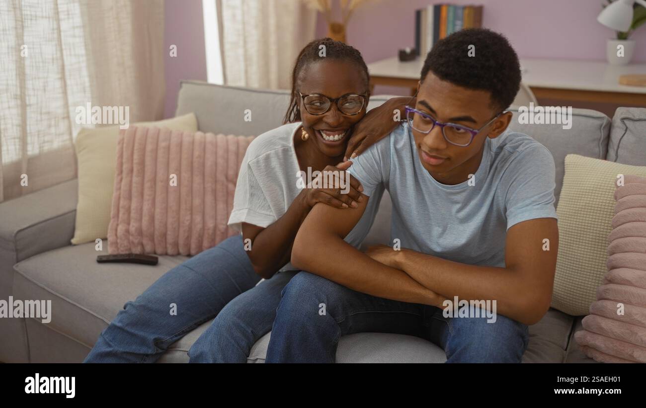 Mother and son enjoying a moment together on the couch in their living ...