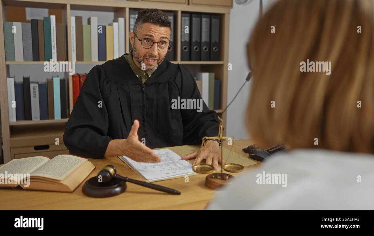 Judge talking to female client in lawyer office with law books and ...