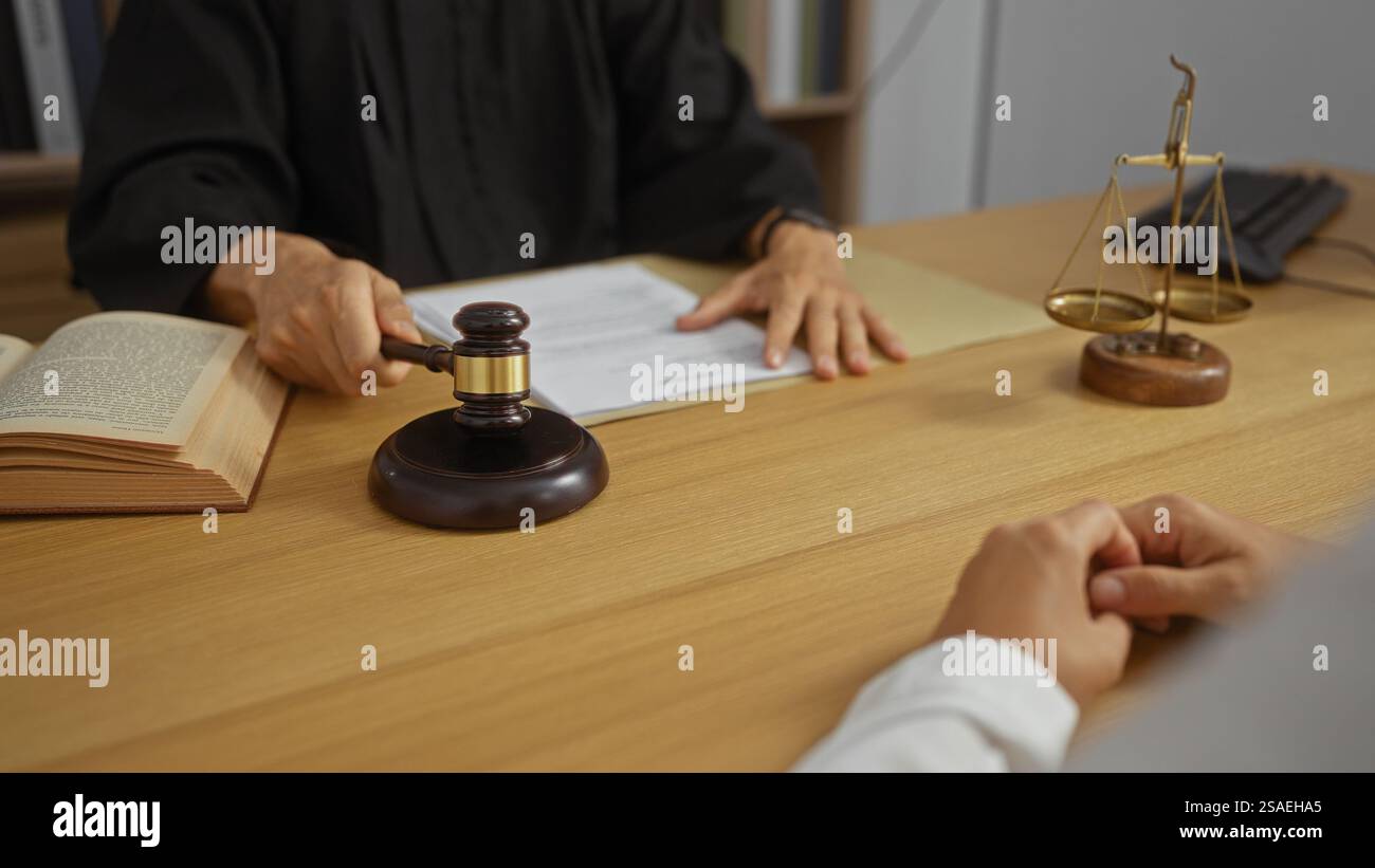 Judge using gavel while listening to client in lawyer office, with open ...