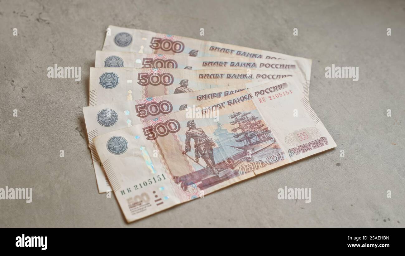 Russian ruble banknotes arranged on a concrete surface, showcasing 500 ...