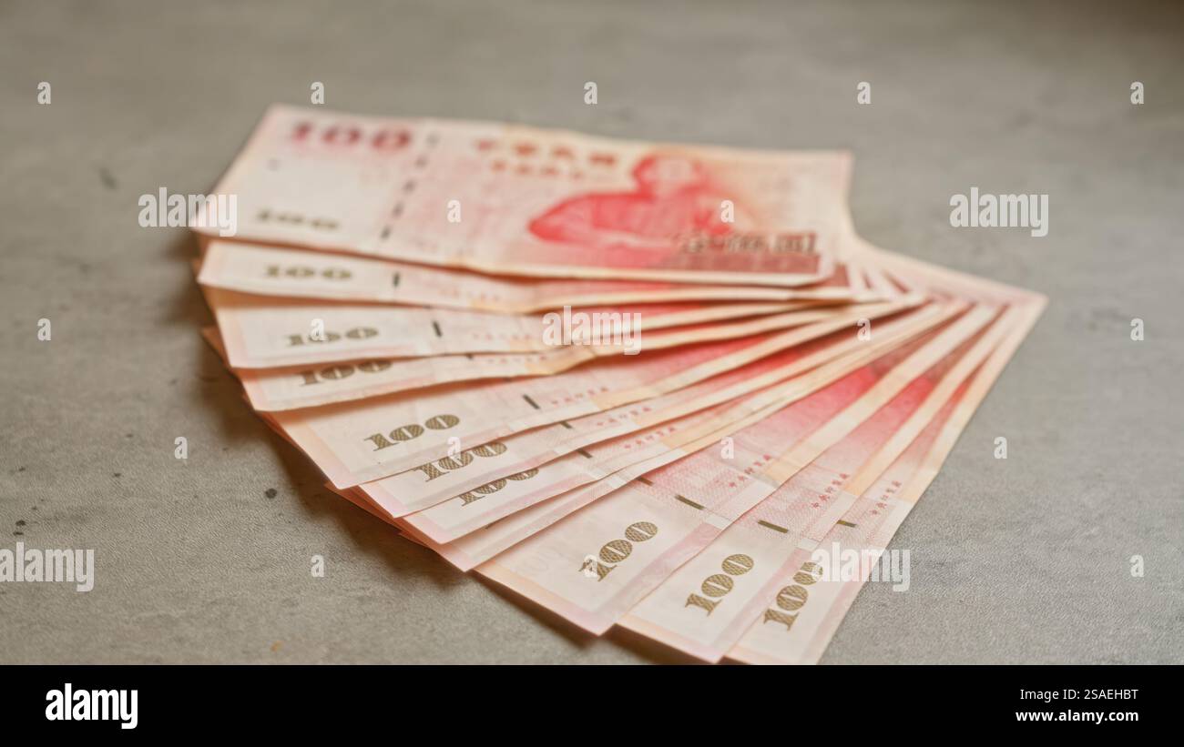 Chinese yuan banknotes laid out on a concrete surface highlighting the ...