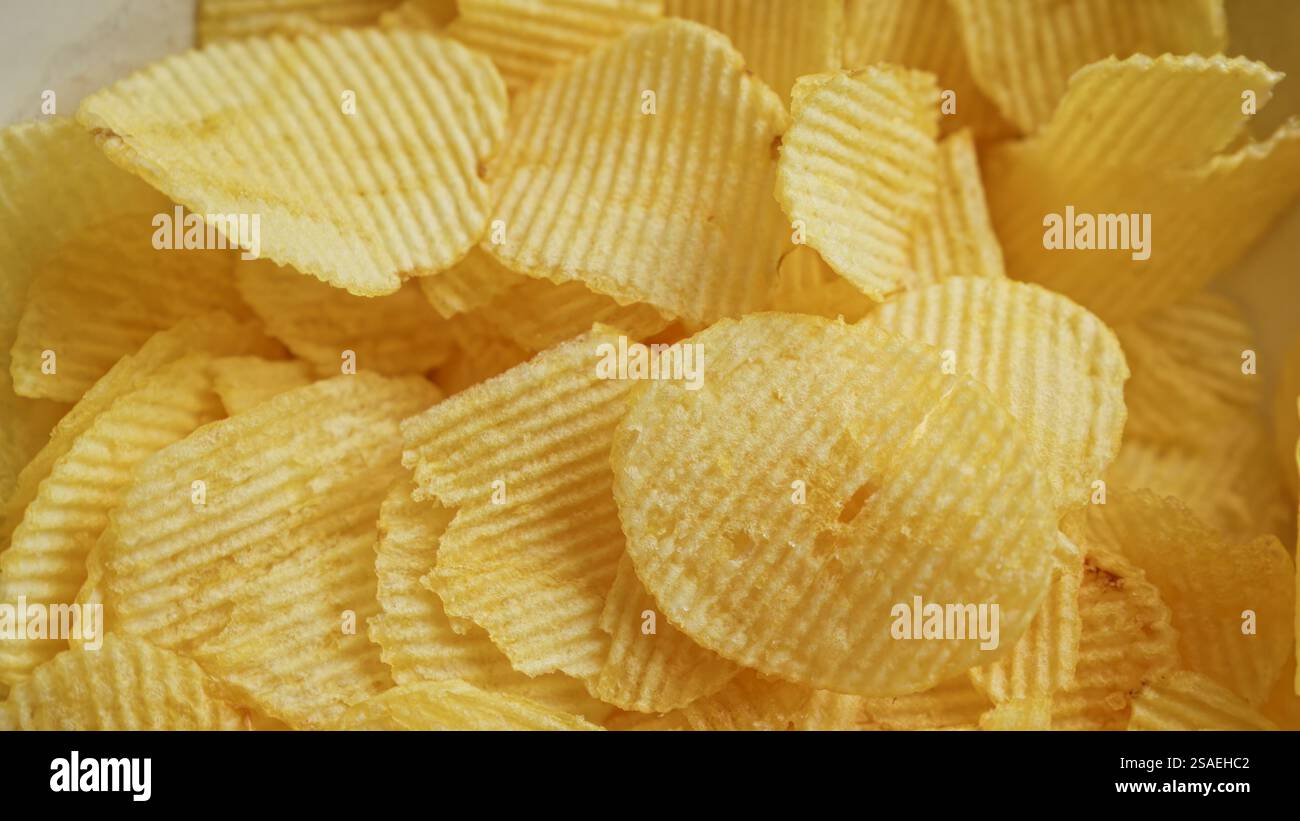 Crispy potato chips arranged in a close-up view displaying the texture ...