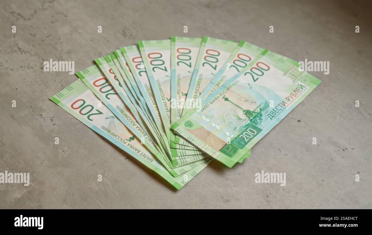 Russian banknotes in green on a concrete surface displaying 200 ruble ...
