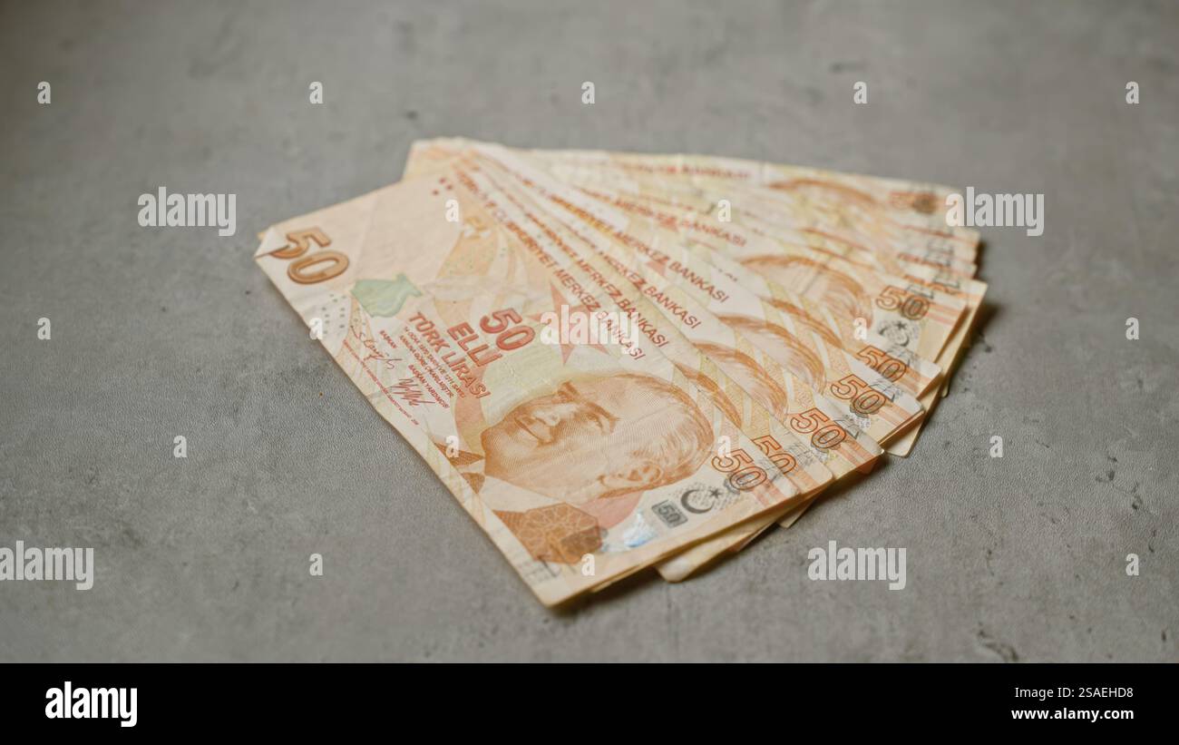 Turkish banknotes scattered on a concrete surface displaying multiple ...