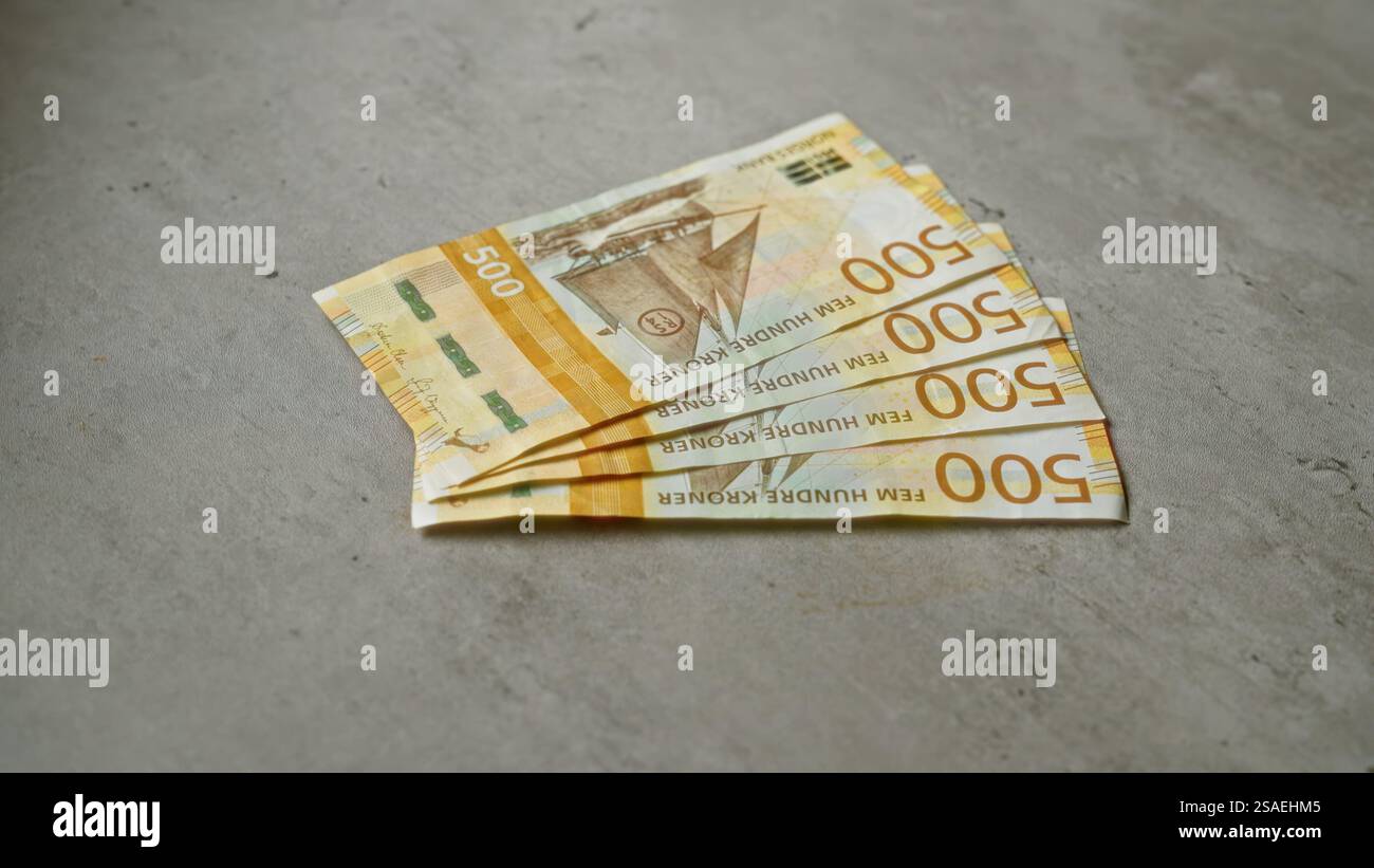 Norwegian kroner banknotes on a concrete surface displaying multiple ...