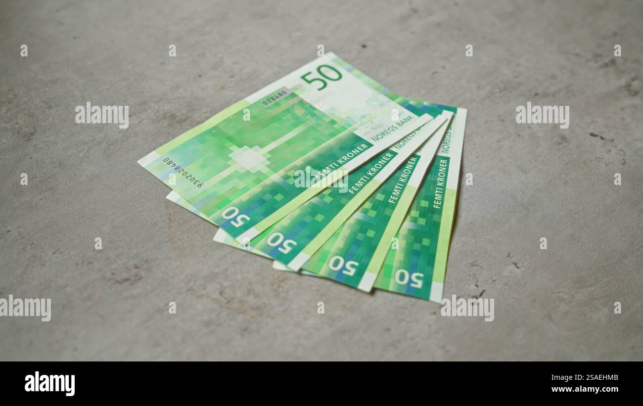 Norwegian banknotes of 50 kroner spread out on a concrete surface Stock ...