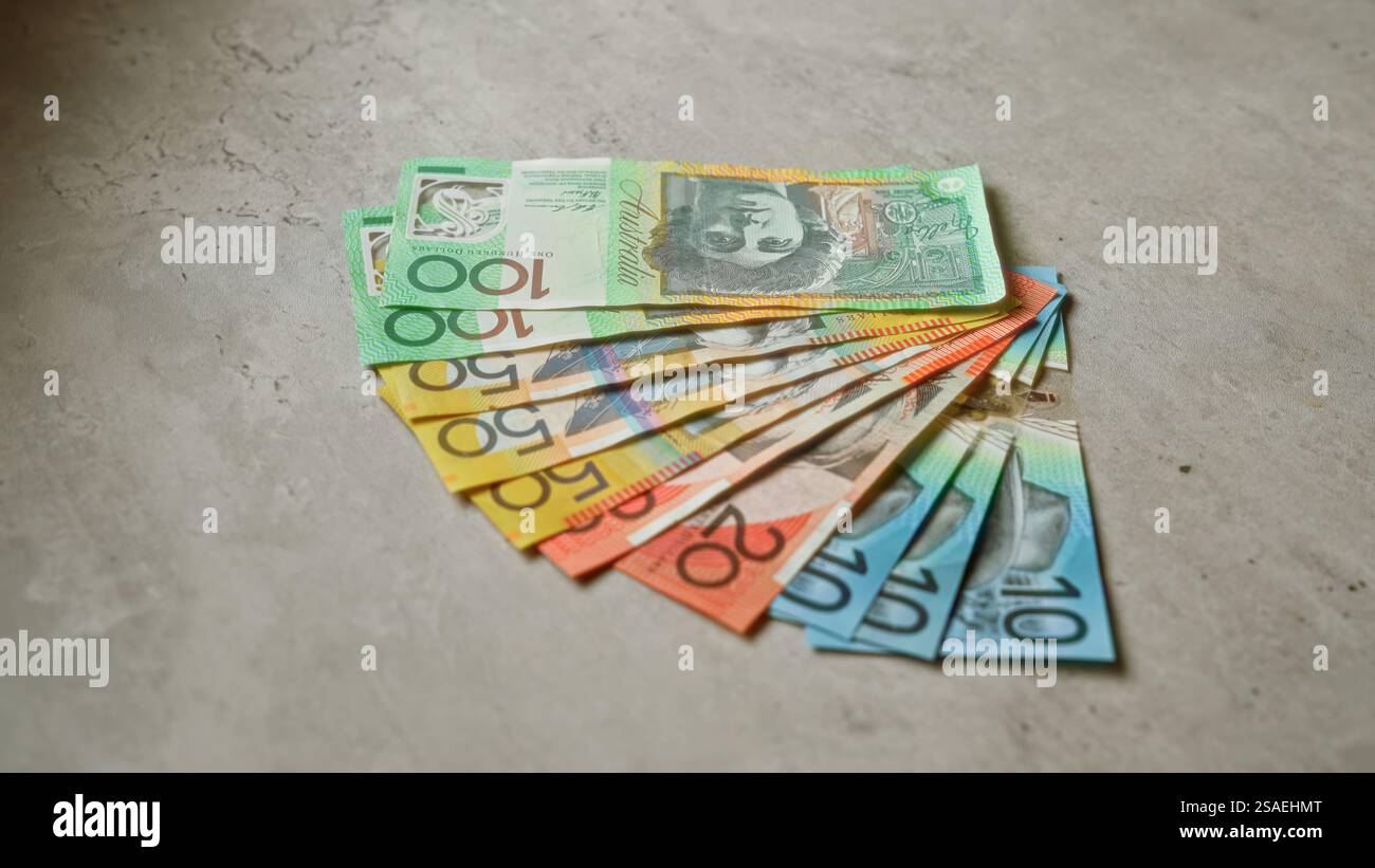 Colorful australian banknotes fanned out on a concrete surface ...