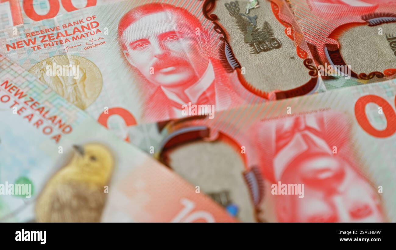 New zealand banknotes scattered on a concrete surface, showcasing vivid ...