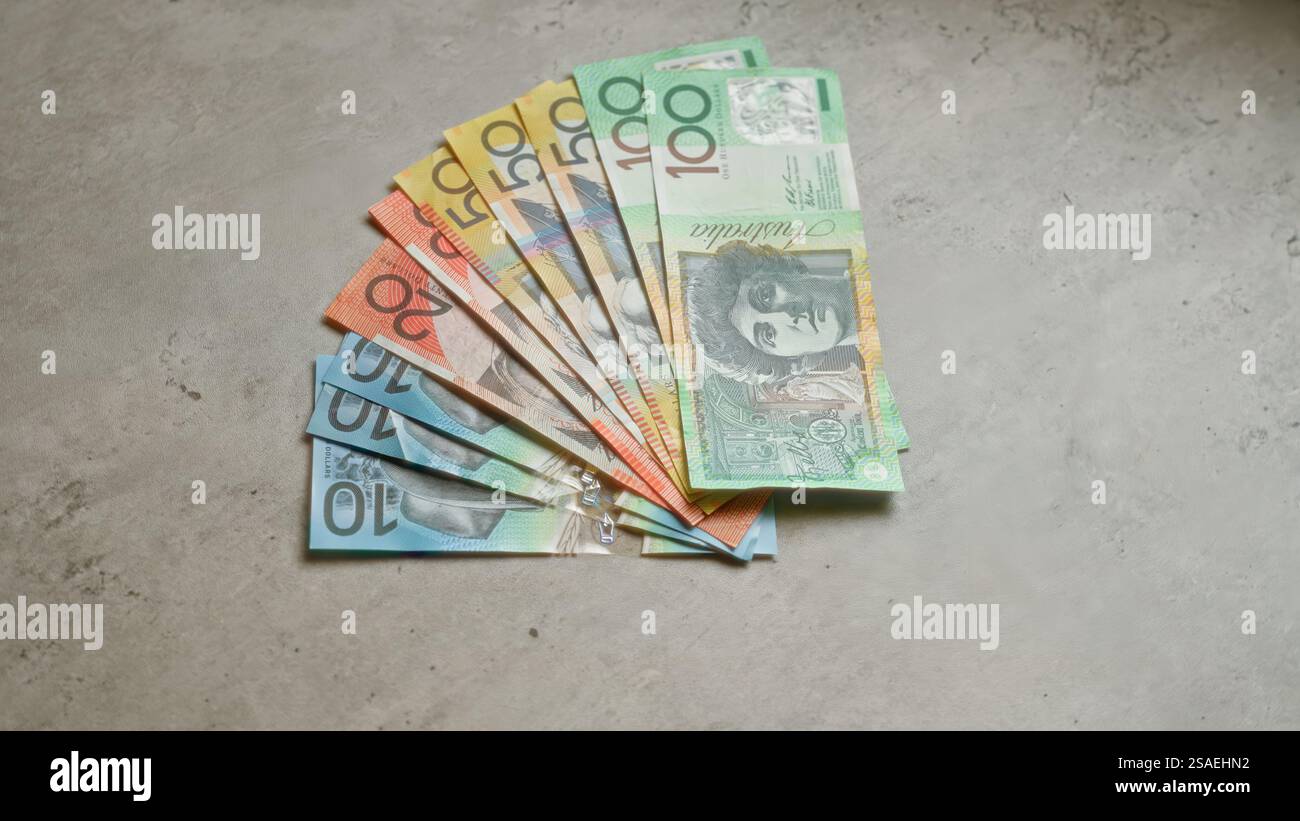 Australian dollar banknotes fanned out on a concrete surface ...