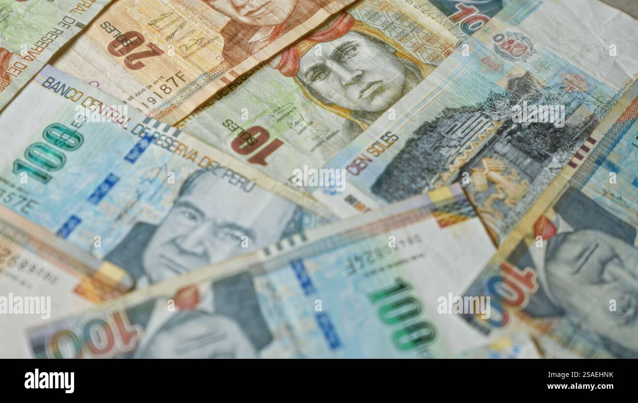 Peruvian banknotes of various denominations scattered showcasing ...