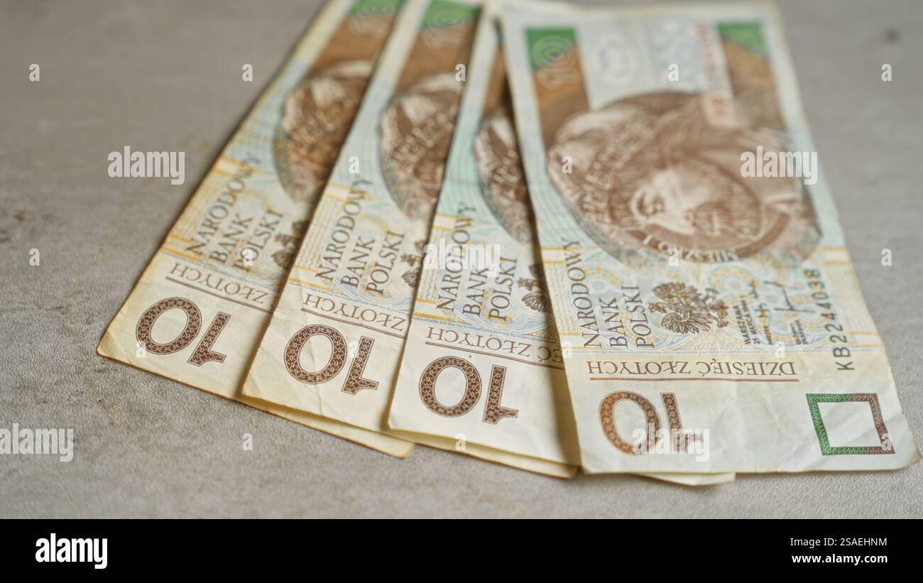 Polish banknotes of 10 zloty placed on a concrete surface, highlighting ...