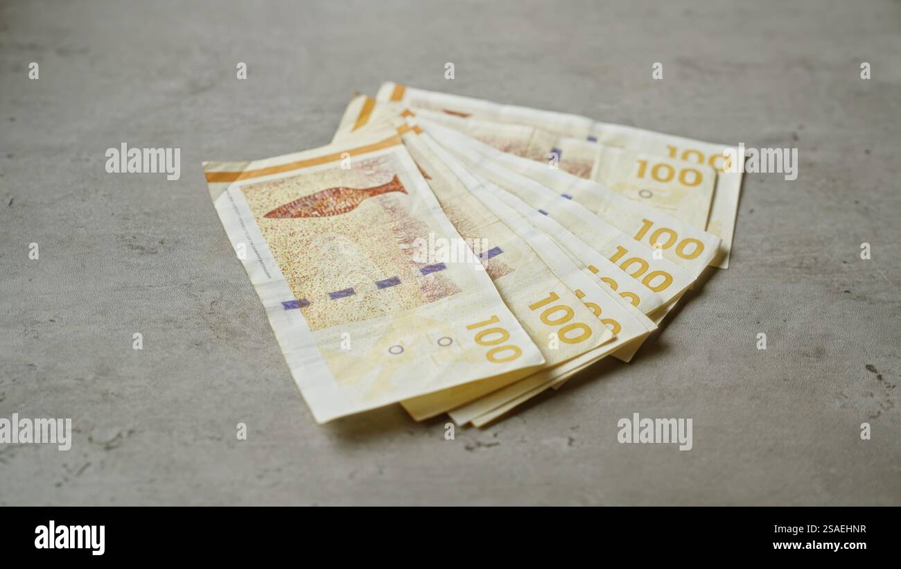 Danish kroner banknotes on a concrete surface depict various ...
