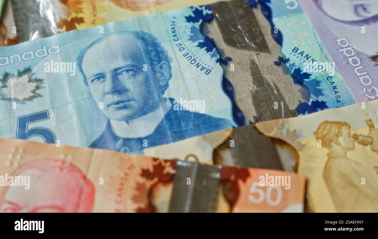 Canadian banknotes in various denominations, including five, ten ...