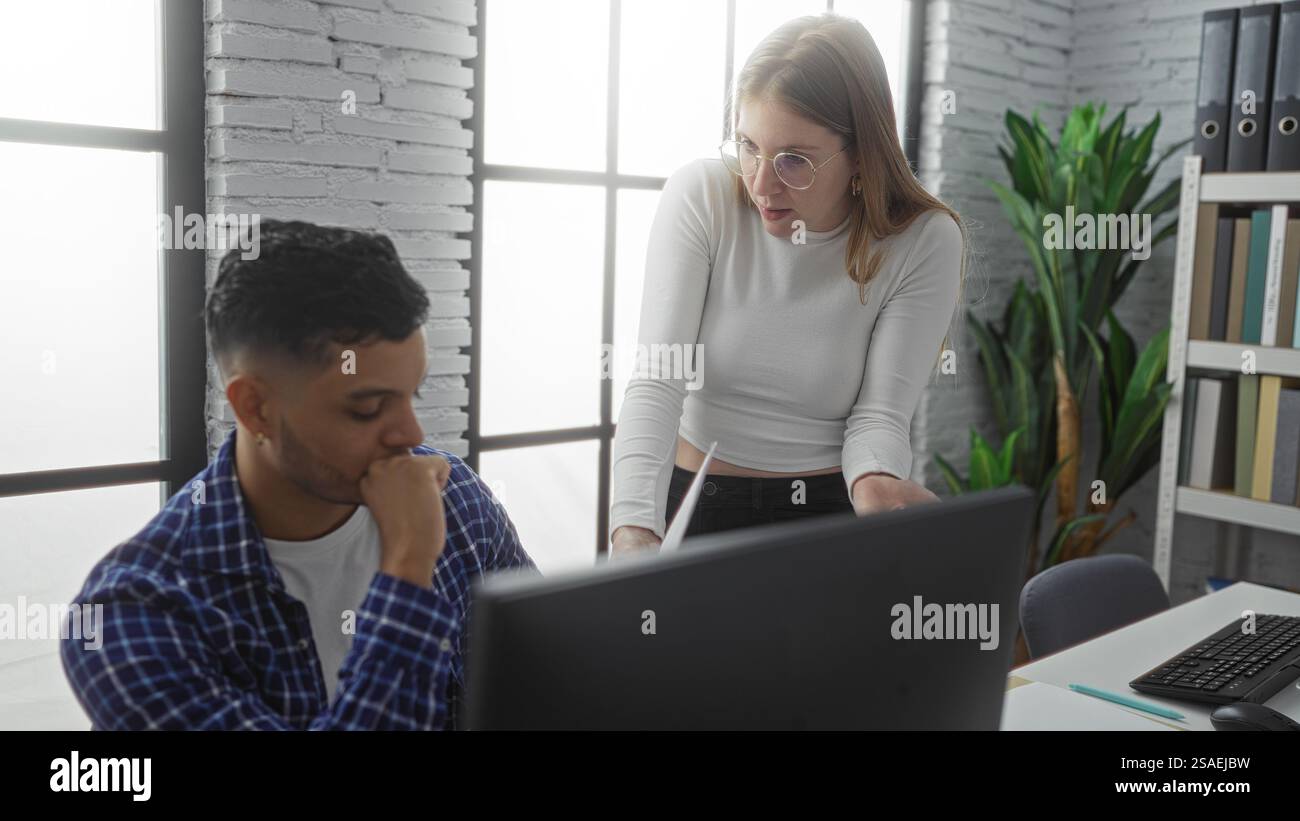 Woman discussing with man in bright office, surrounded by natural ...