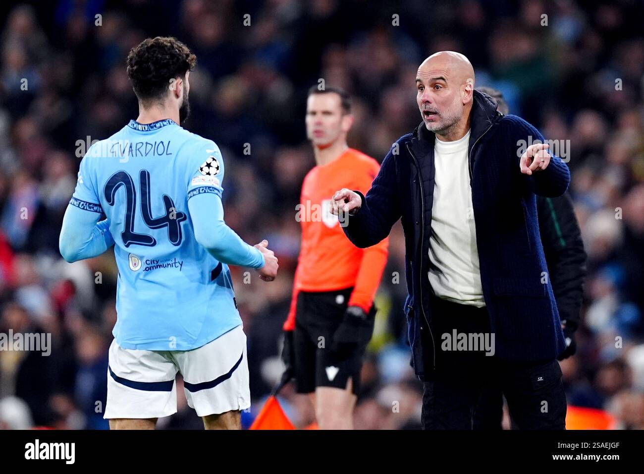 Manchester City manager Pep Guardiola (right) issues instructions to ...