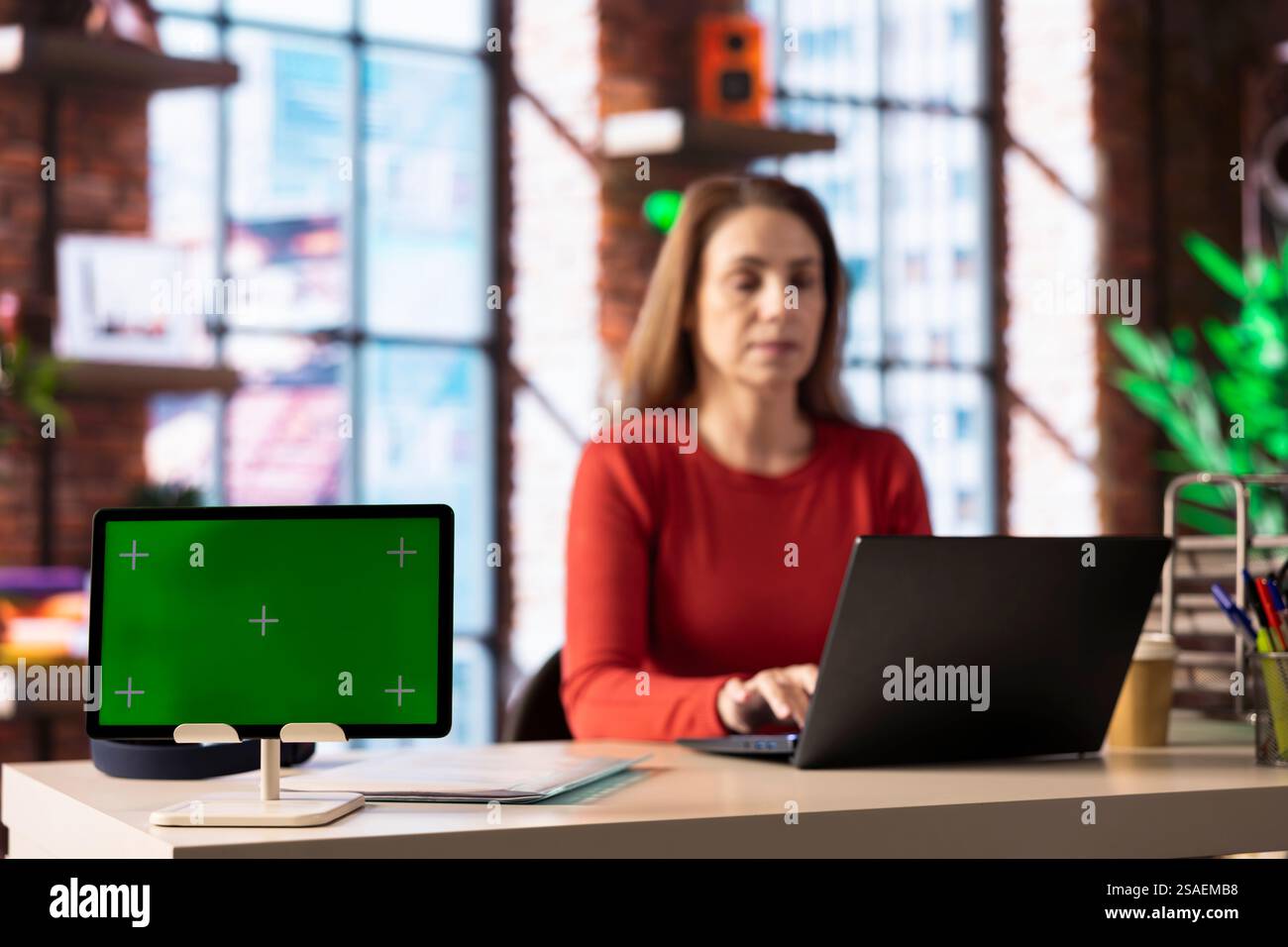 Freelancer uses laptop for creative projects and tasks next to isolated ...