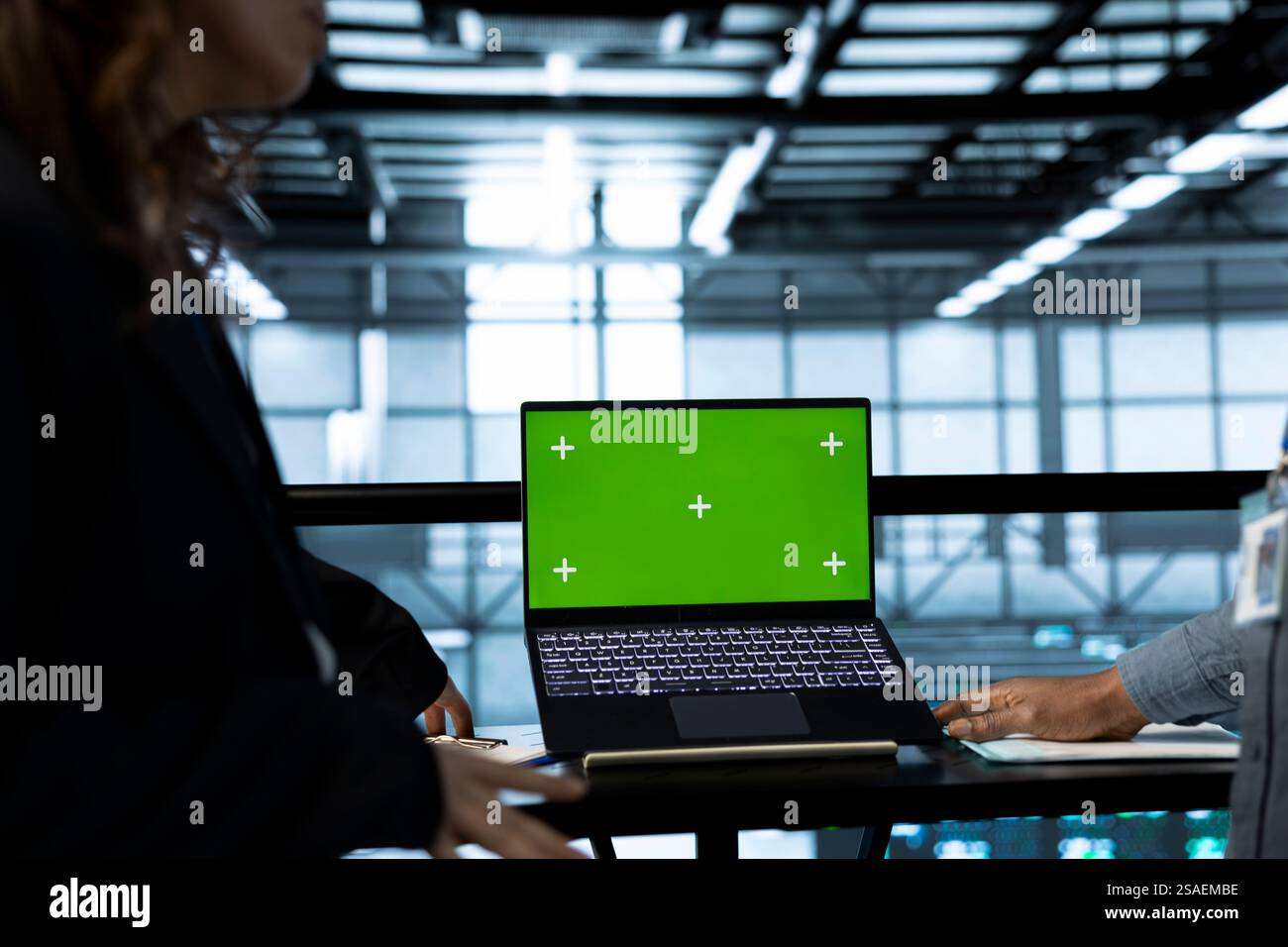 Computer scientists in data center using isolated screen mockup laptop to do network ...
