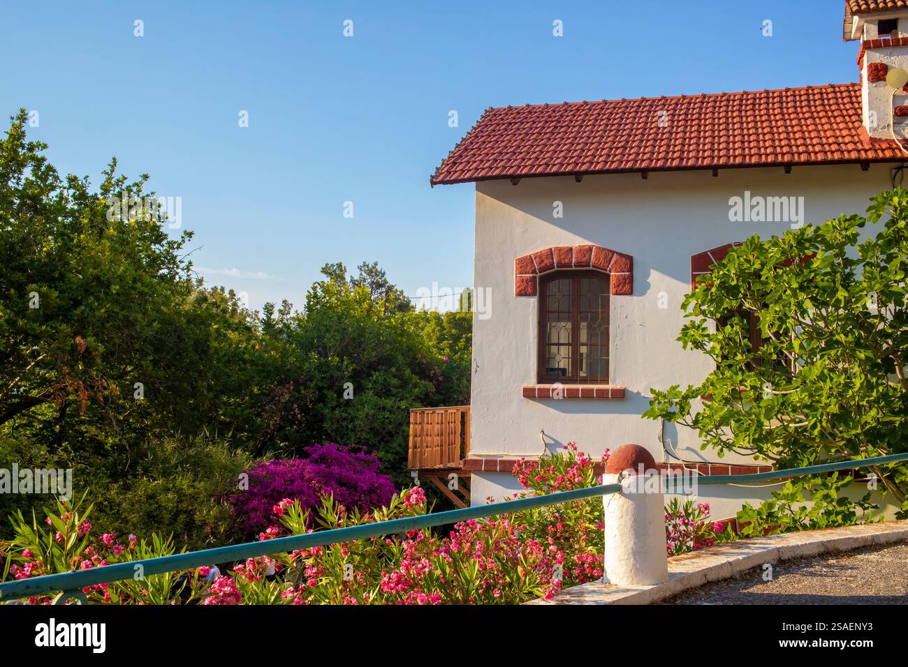 Traditional Greek house with red tiled roof and white walls overlooking ...