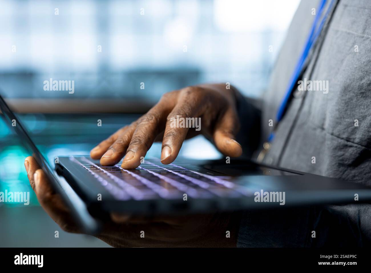 Employee in data center typing on laptop keyboard, analyzing metrics, optimizing storage volumes ...