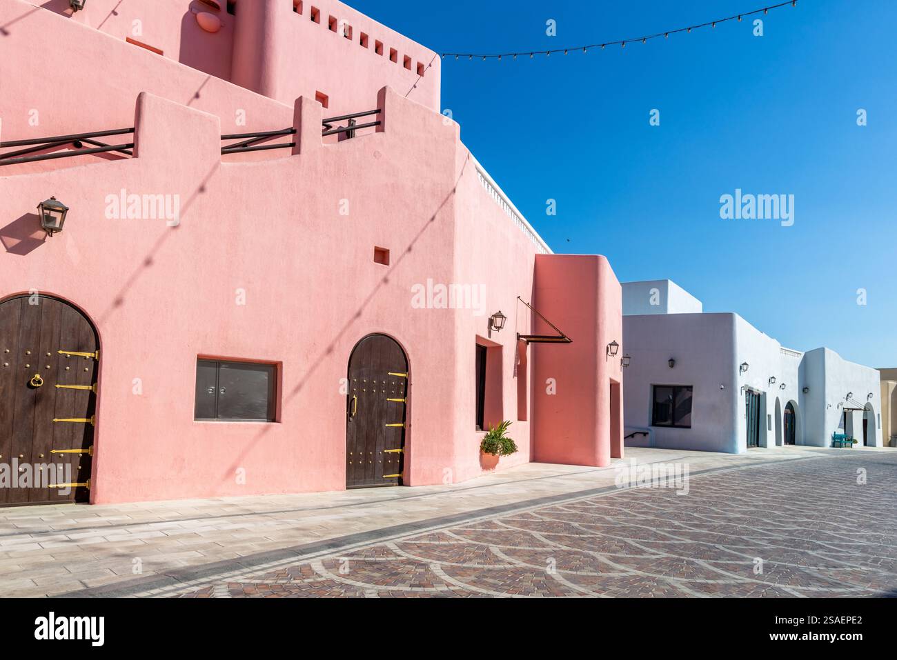 Colorful Mina village district street with arab traditional shaped ...