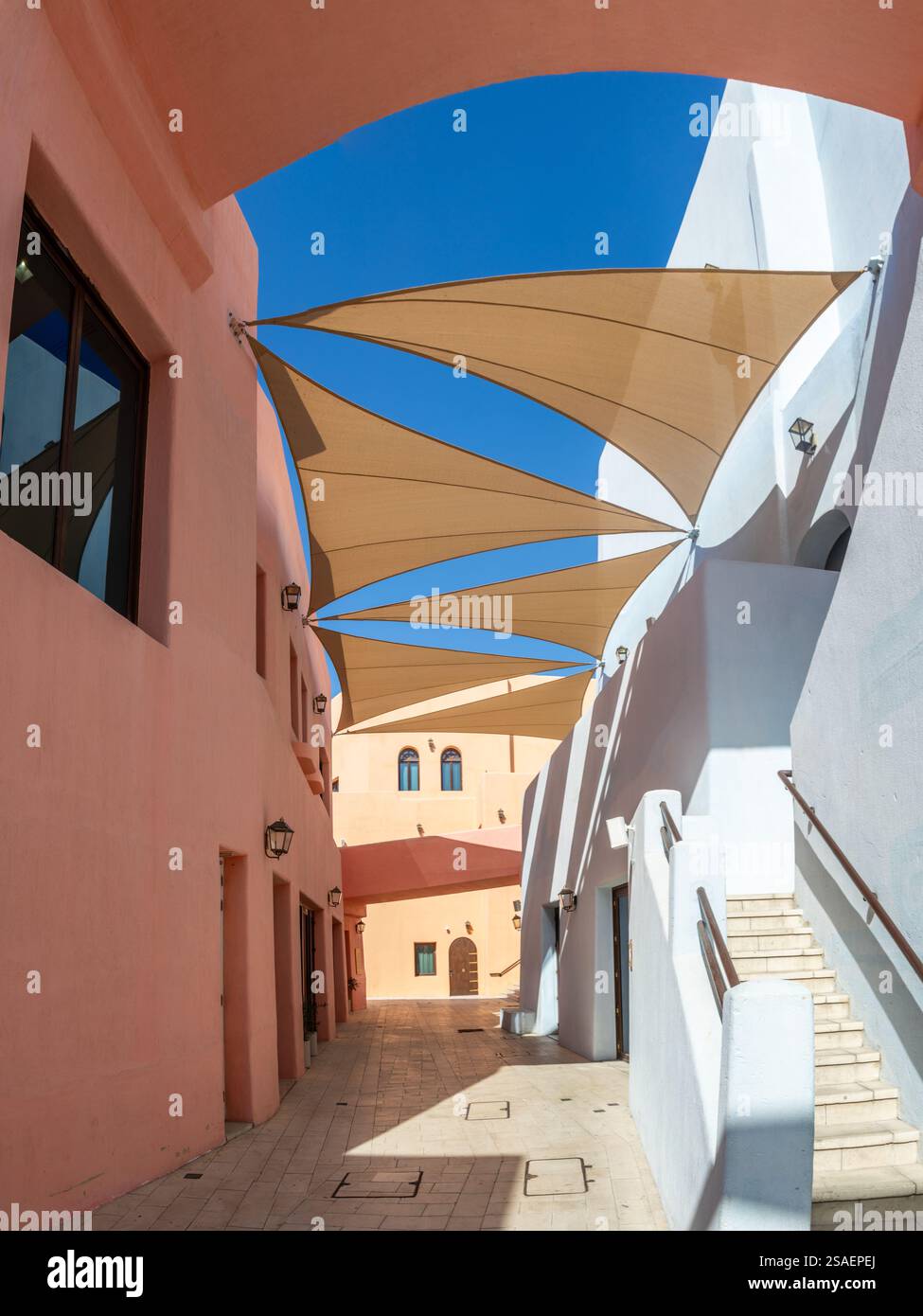 Colorful Mina village district street with sunlight canopy cover and ...
