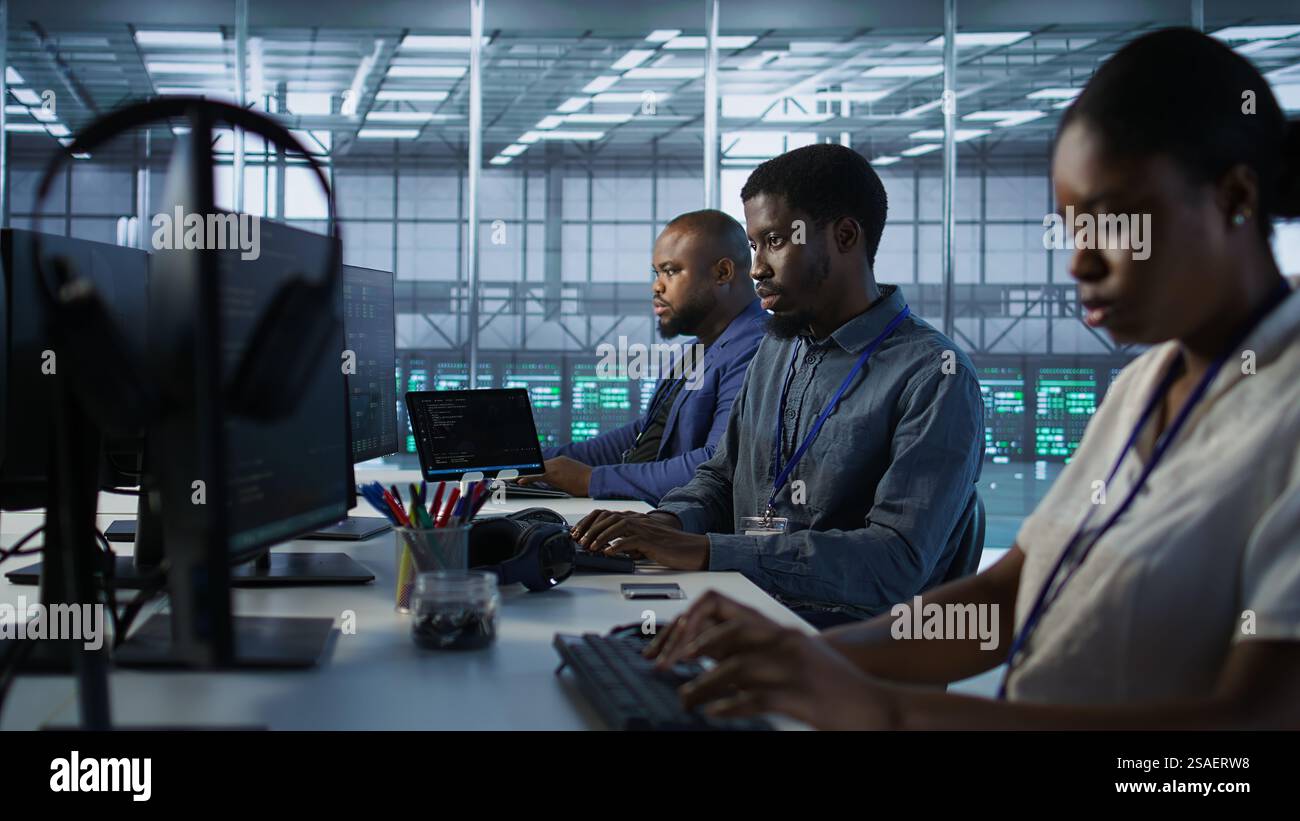 African american data center technicians implement AI predictive maintenance systems. Woman in ...