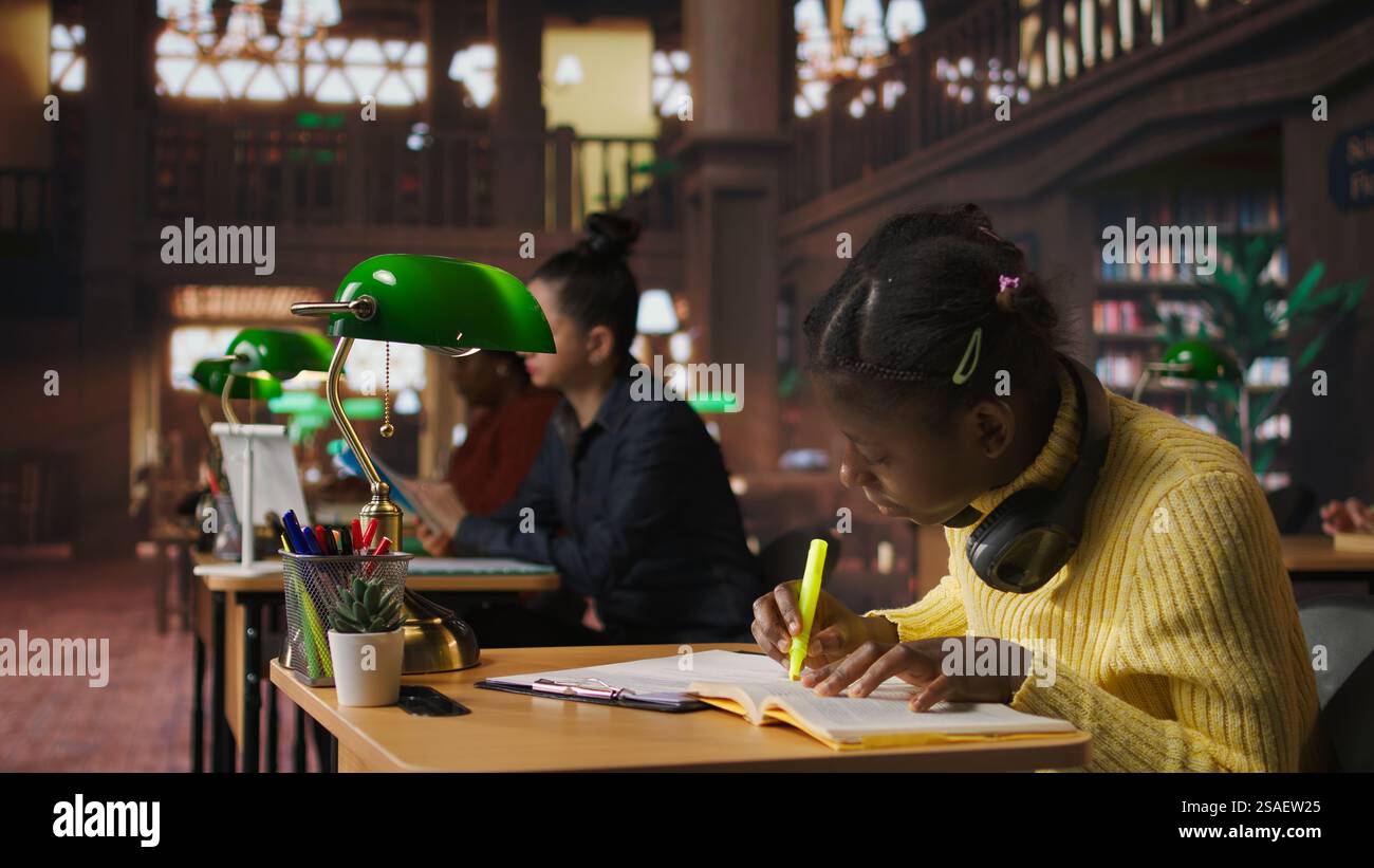 African american schoolgirl using fluorescent pen to highlight key ...
