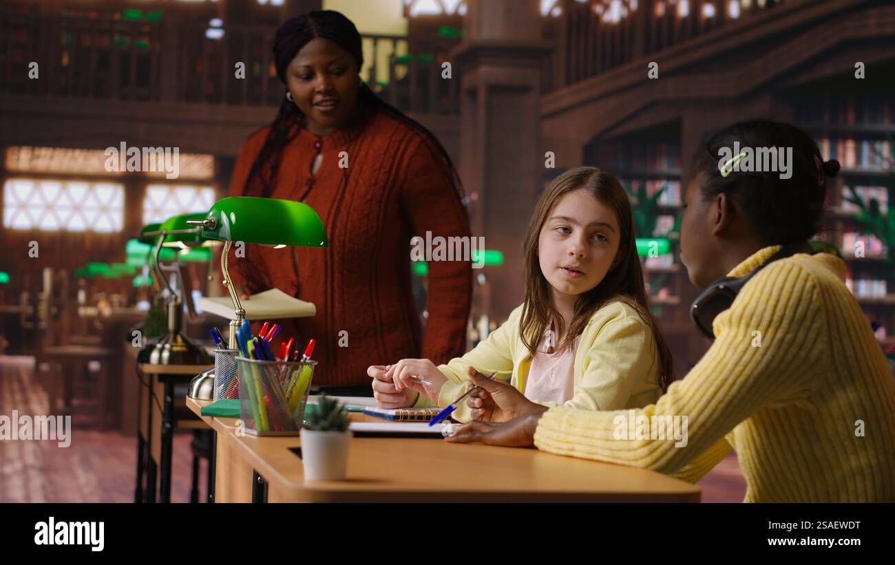 Teacher assisting scholars with class homework for mentoring session ...