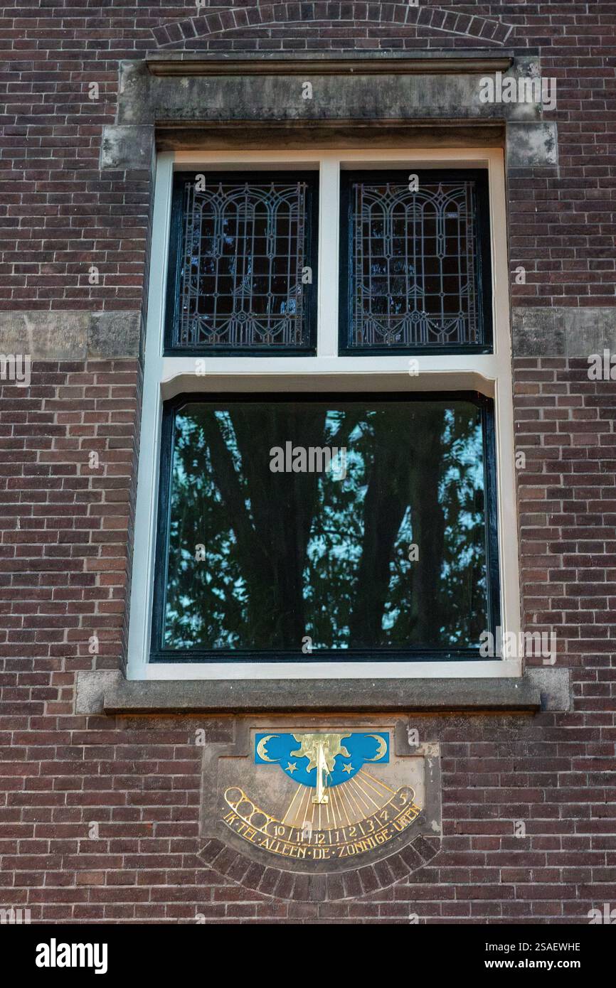 A brick building facade with a decorative window featuring stained ...