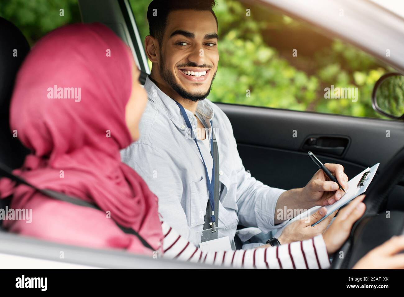 Driving School Test. Handsome Young Arab Instructor Examining Muslim ...