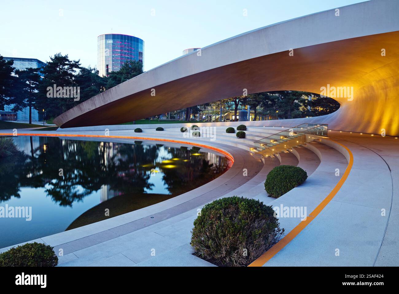 illuminated Porsche pavilion in the evening in the Autostadt, glass car ...