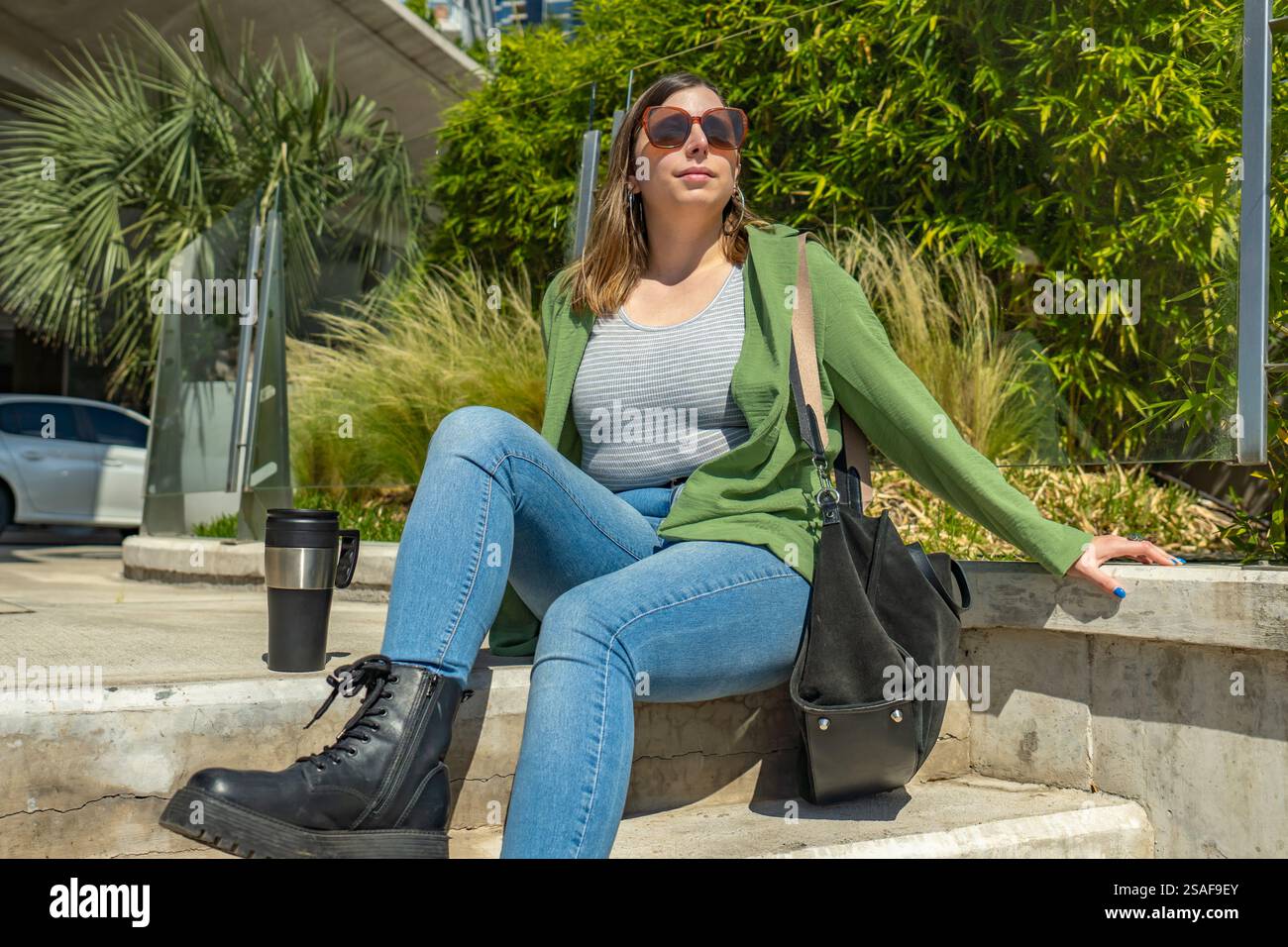 Female professional sitting outdoors sipping hi-res stock photography ...