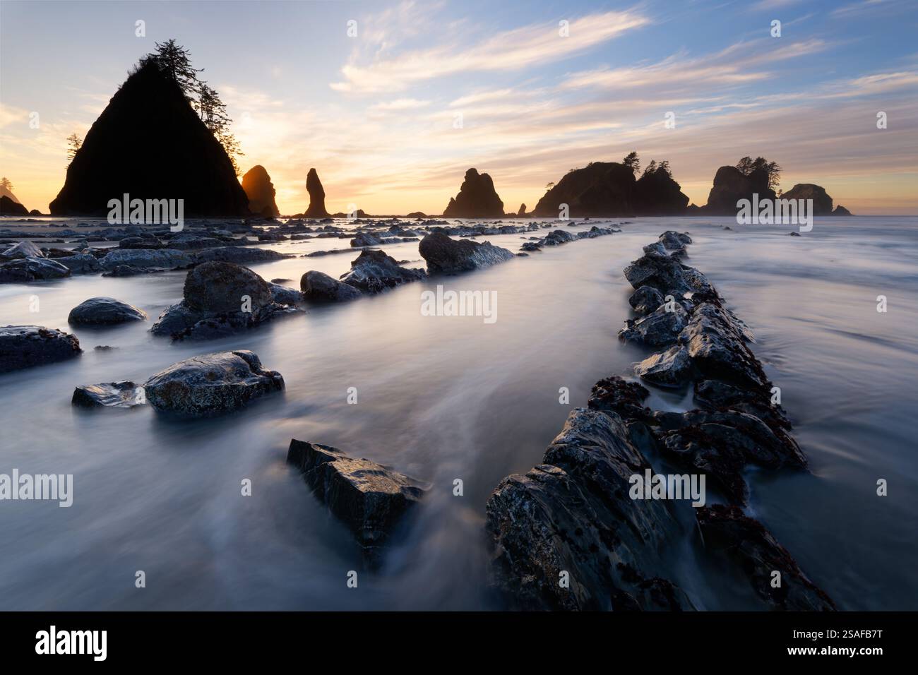 Water washing over linear rock formations at base of off-shore sea ...