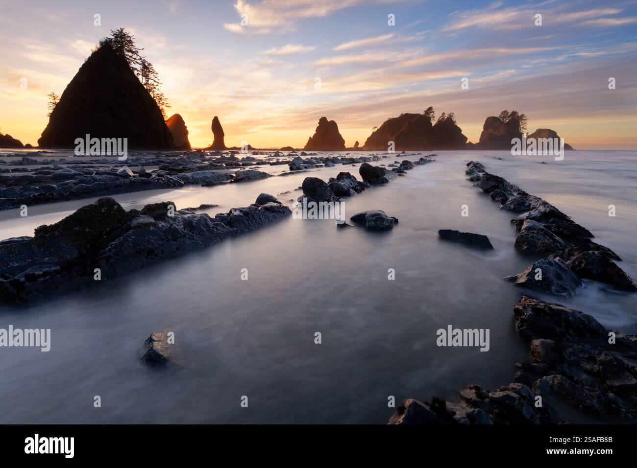 Water washing over linear rock formations at base of off-shore sea ...