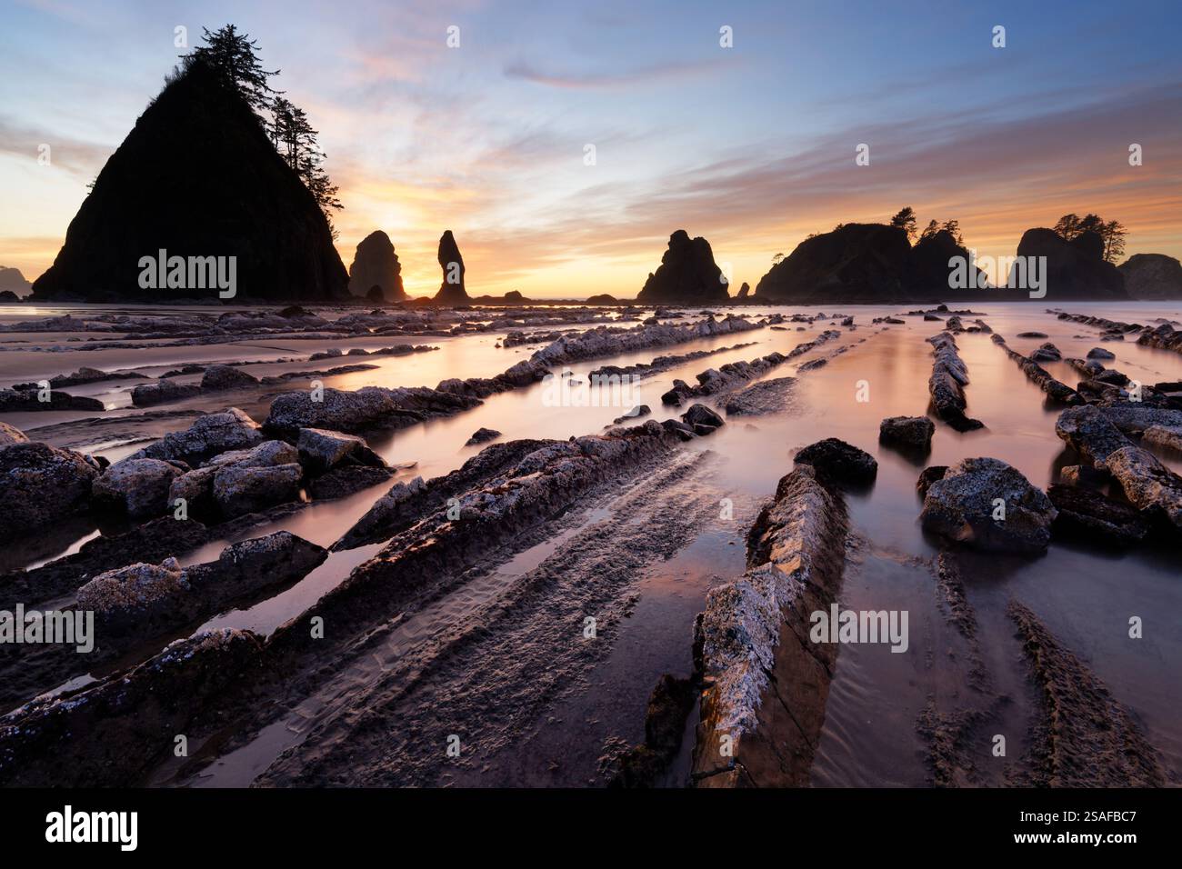 Water washing over linear rock formations at base of off-shore sea ...