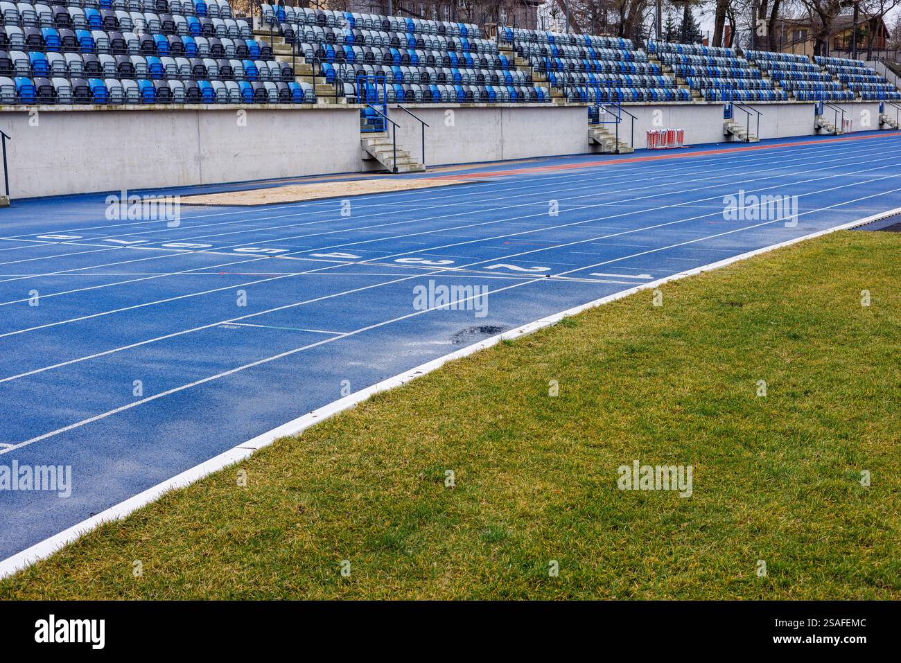 Blue running tracks with numbers. Plastic folding seats at the city ...