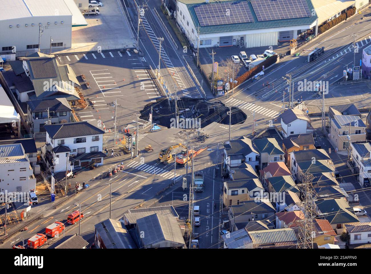 An aerial photo shows sinkholes at an intersection in Yashio City ...