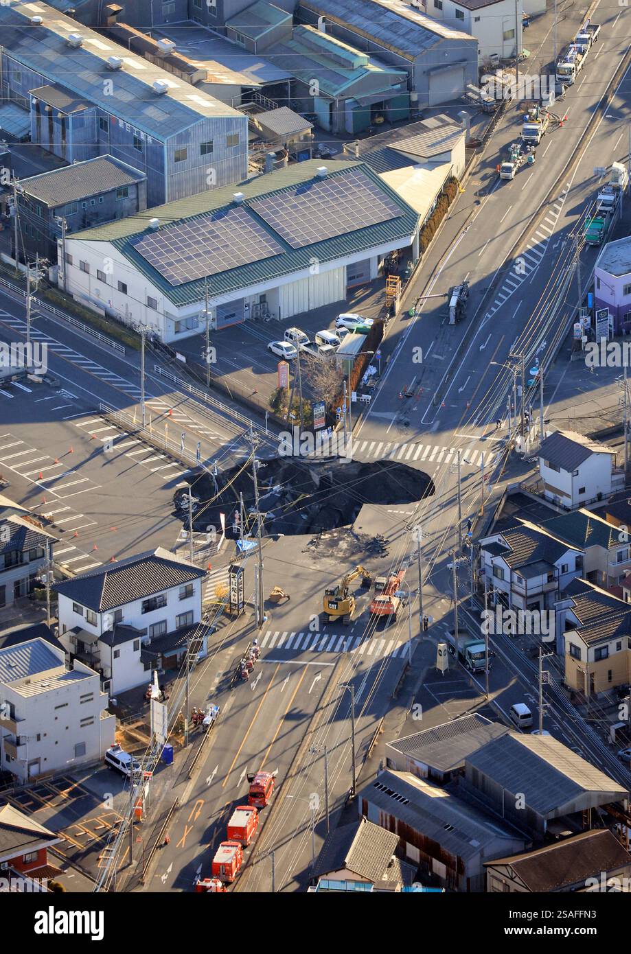 An aerial photo shows sinkholes at an intersection in Yashio City ...