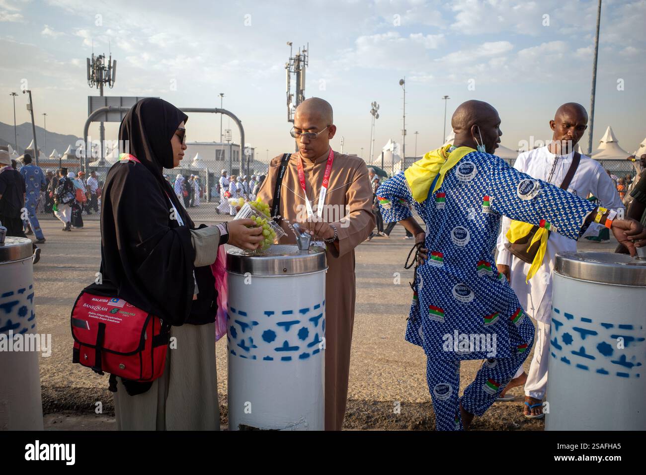 Mecca, Saudi Arabia - June 17, 2024: Pilgrims from Malaysia and Burkina Faso standing near a ...
