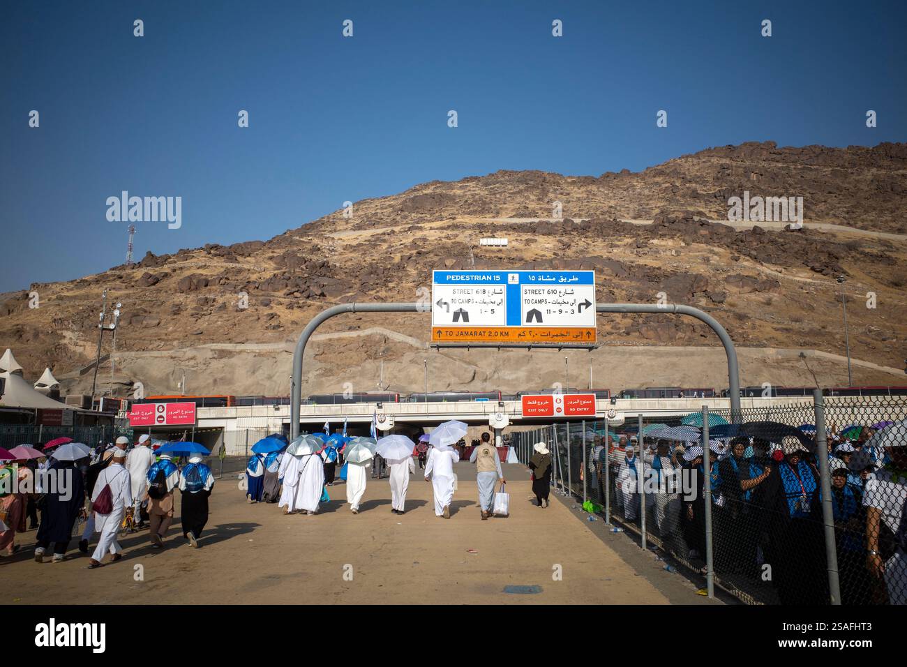 Mecca, Saudi Arabia - June 17, 2024: Pilgrims walking towards the Jamarat stoning ritual in Mina ...