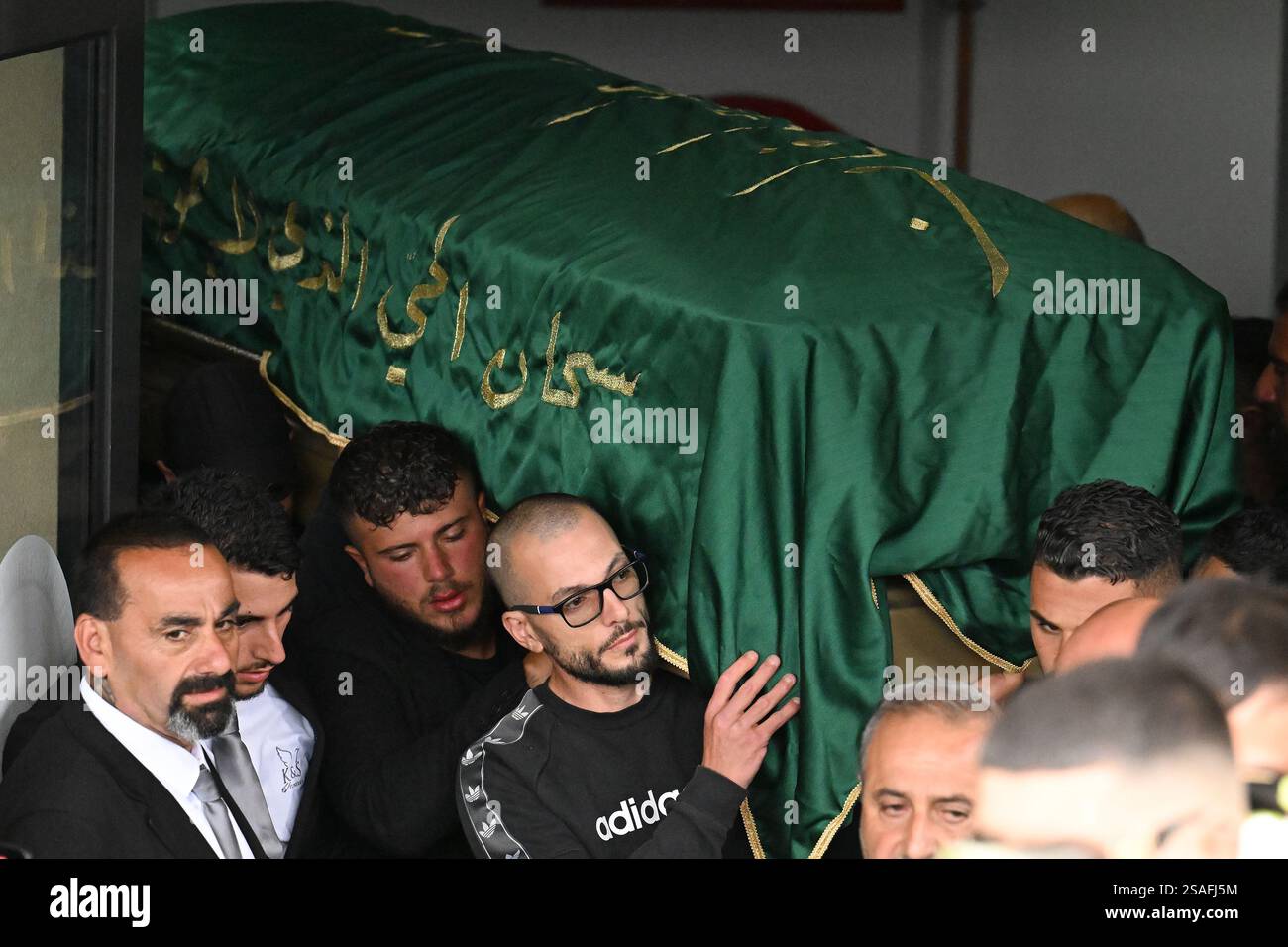 Melbourne, Australia. 30th Jan, 2025. Pallbearers carry the casket to a ...