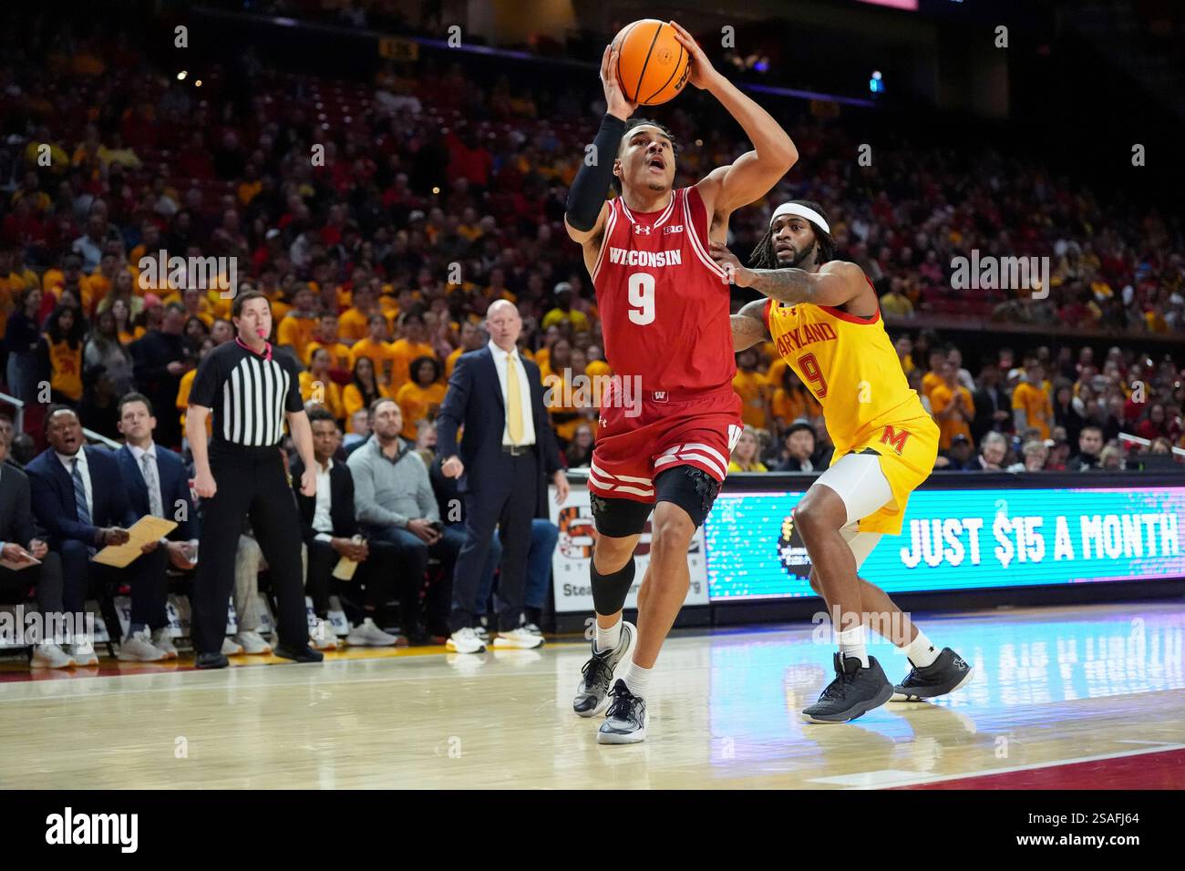 Wisconsin guard John Tonje, left, looks to shoot as Maryland guard ...