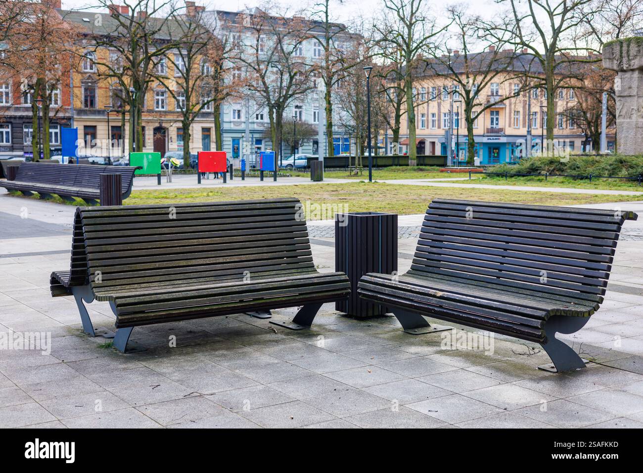 Double and regular wooden benches in a city park. Benches against the ...