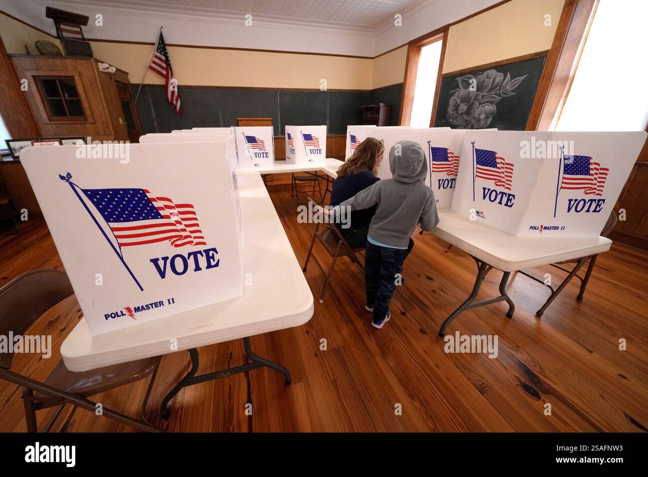 FILE - Aliza Bidinger is accompanied by her son Jayce, as she votes at ...