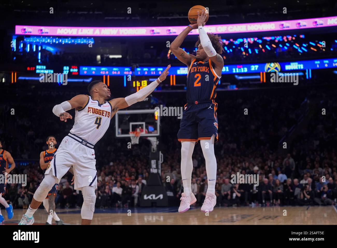 New York Knicks' Miles McBride (2) shoots over Denver Nuggets' Russell ...