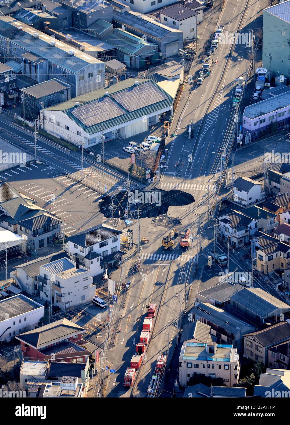 An aerial photo shows sinkholes at an intersection in Yashio City ...