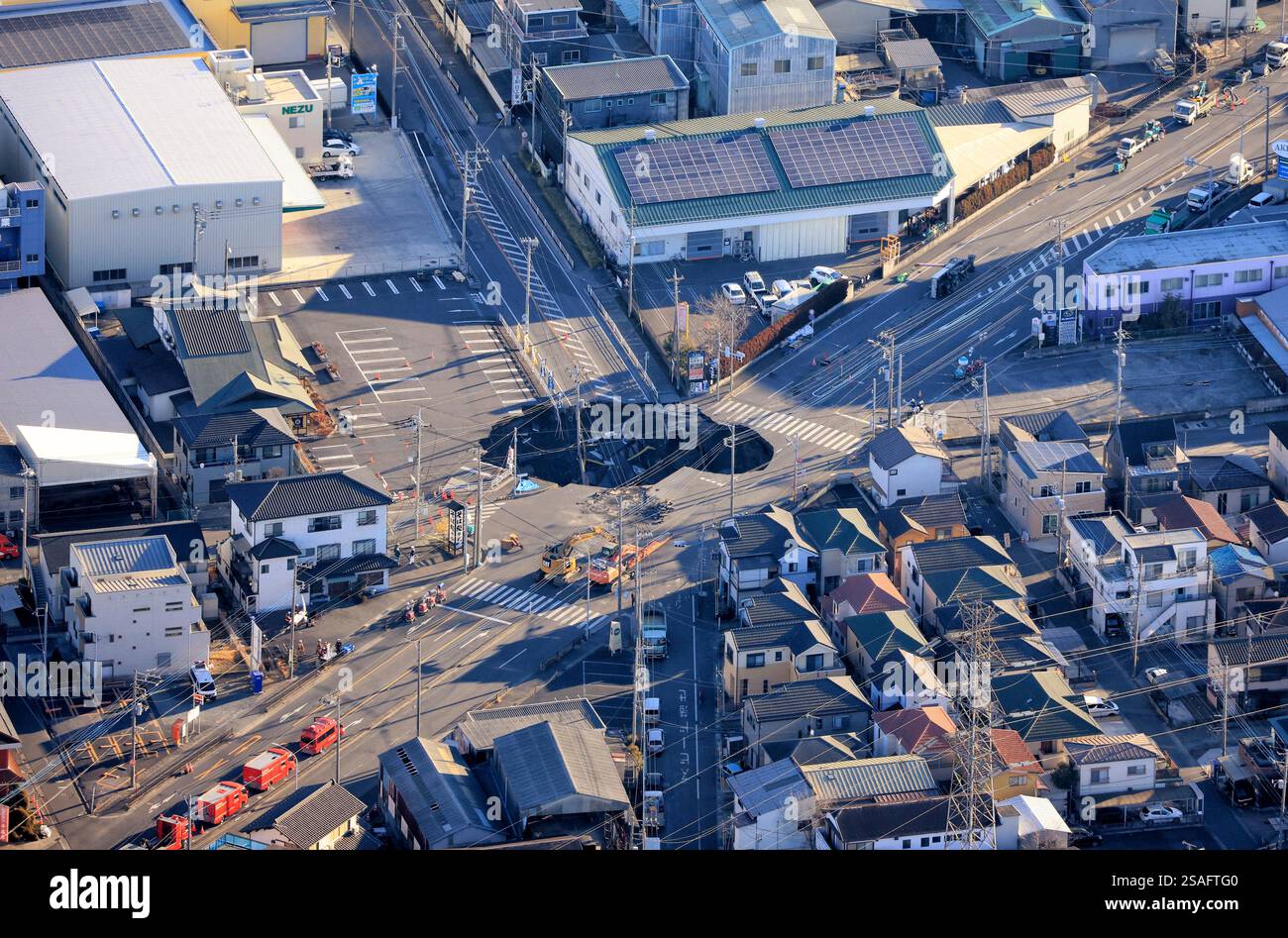 An aerial photo shows sinkholes at an intersection in Yashio City ...