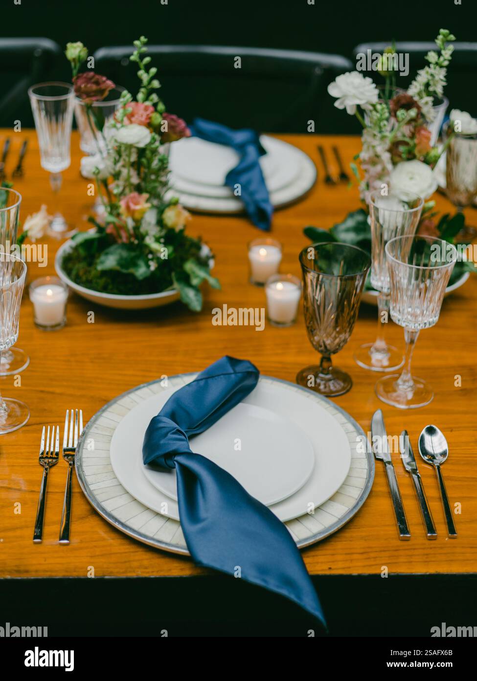 A beautifully arranged dinner table showcases elegant plates and ...