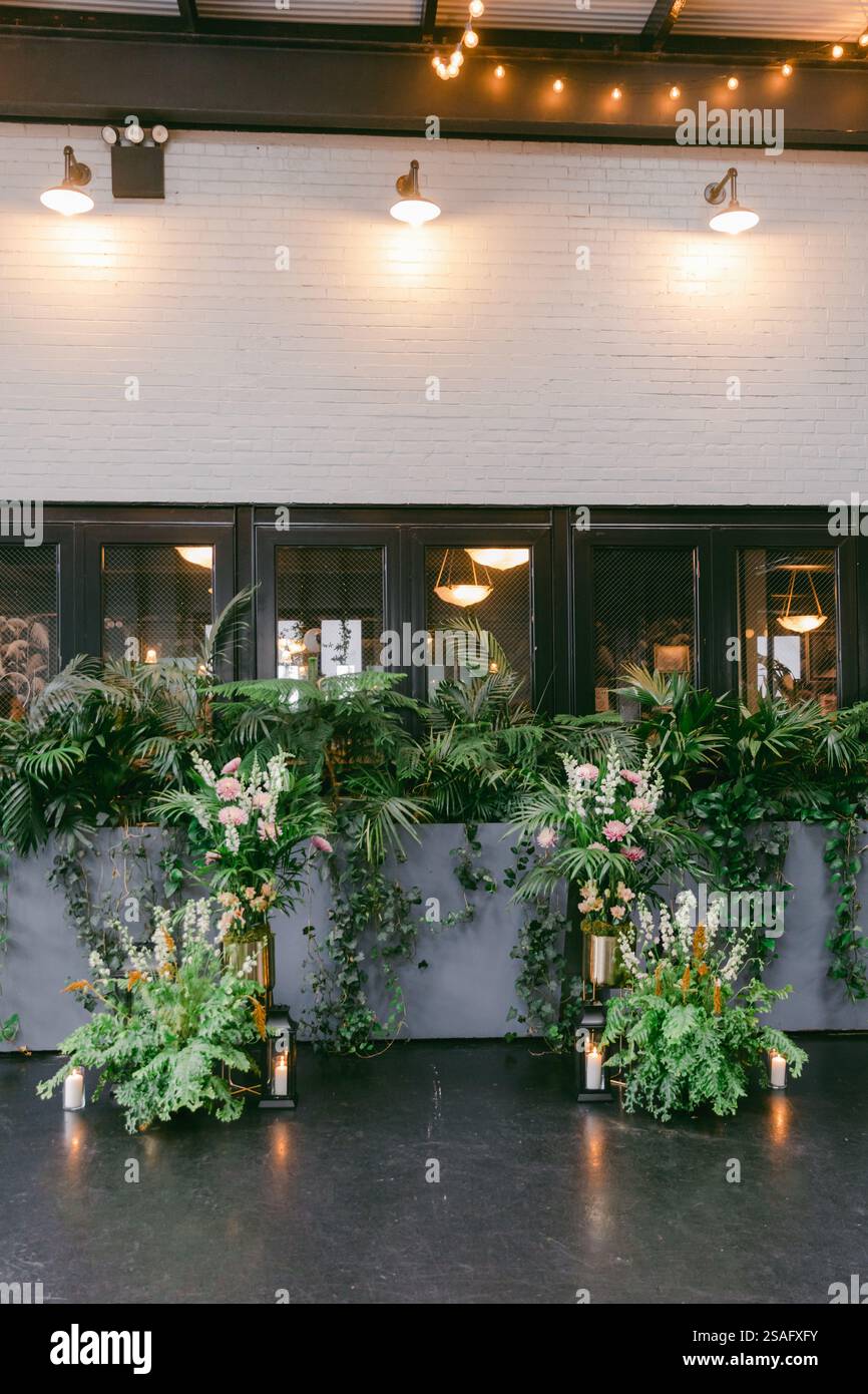 Decorative indoor venue features vibrant plants, elegant floral ...