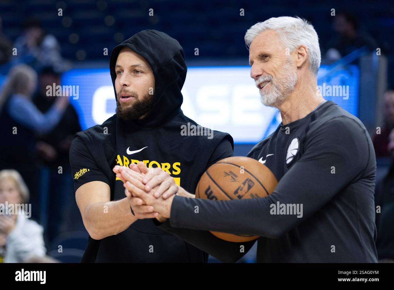 Golden State Warriors guard Stephen Curry stands with assistant coach ...